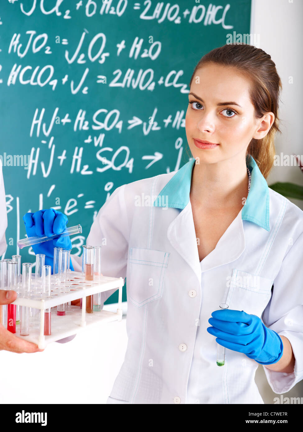 Woman chemistry student with flask in classroom Stock Photo - Alamy