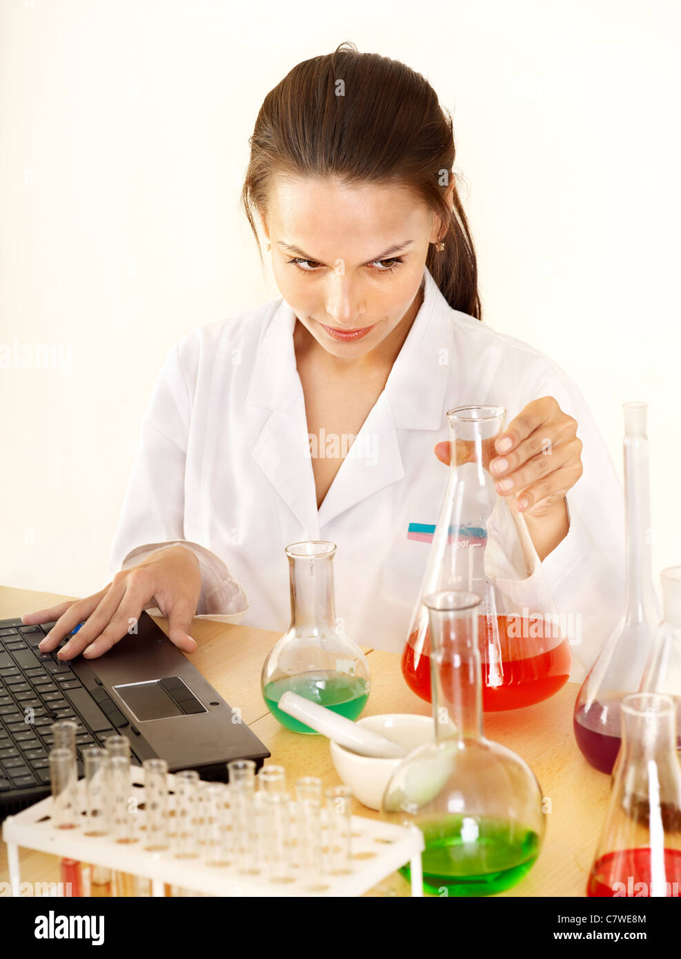 Woman chemistry student with flask in classroom Stock Photo - Alamy