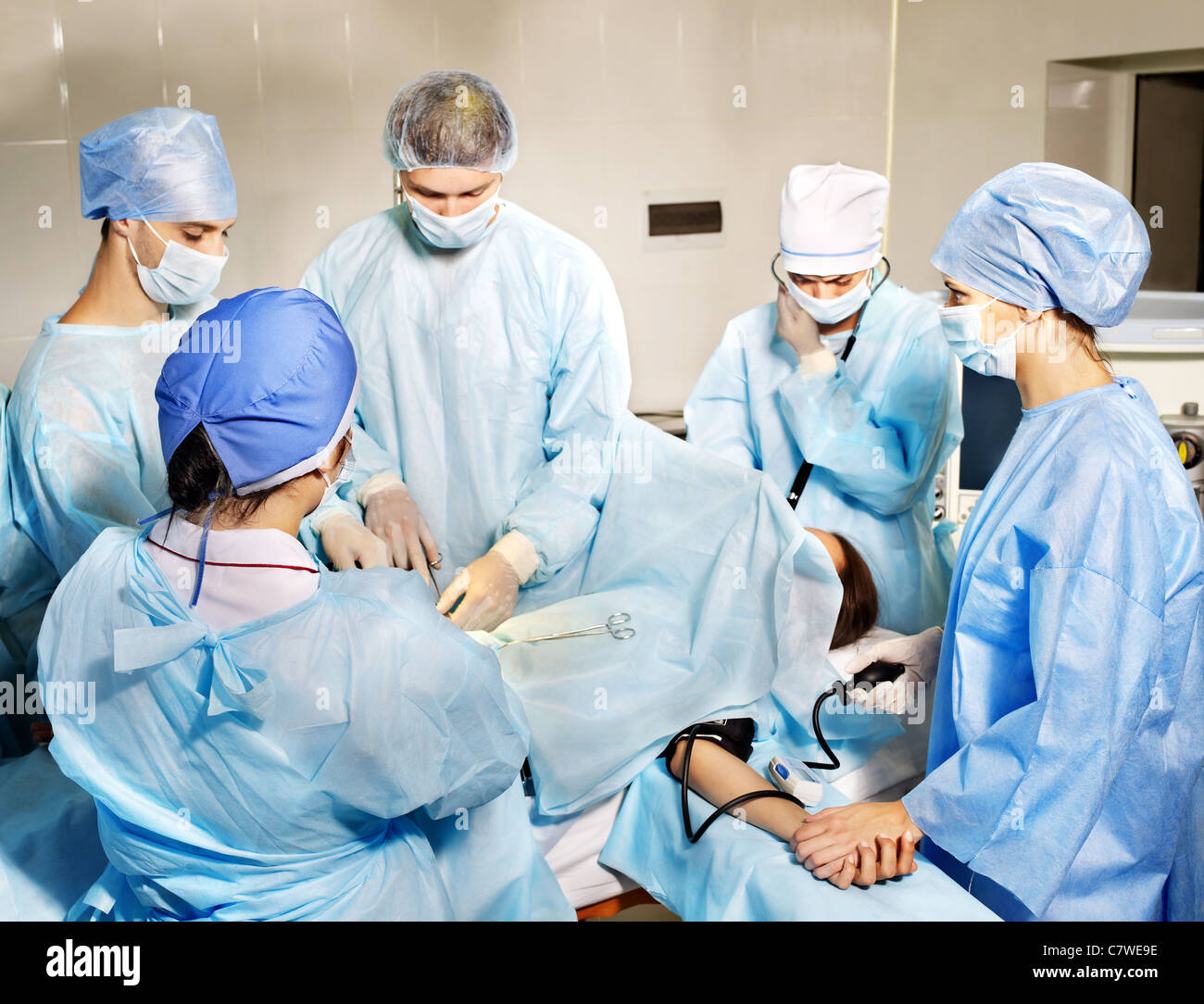 Group of surgeon looking at patient in operation room Stock Photo - Alamy