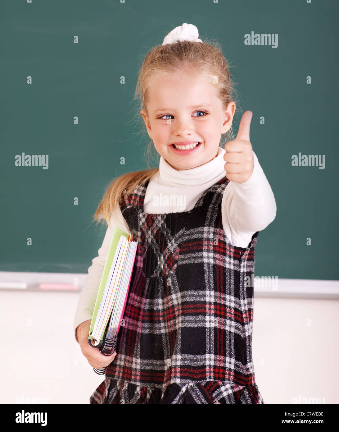 Happy schoolchild in classroom near blackboard Stock Photo - Alamy