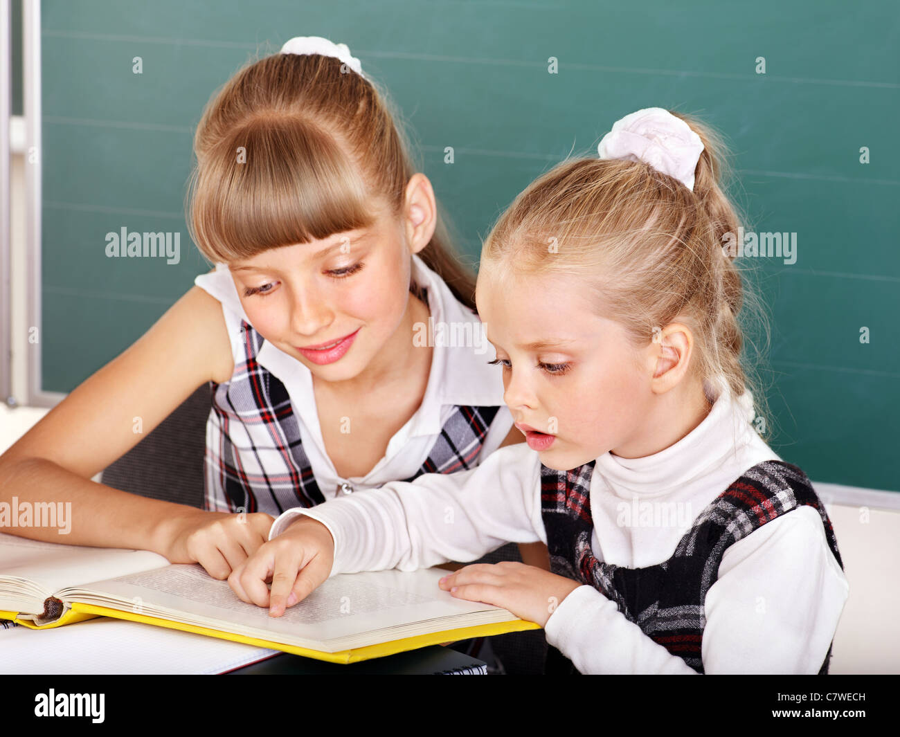 Happy schoolchild in classroom near blackboard Stock Photo - Alamy