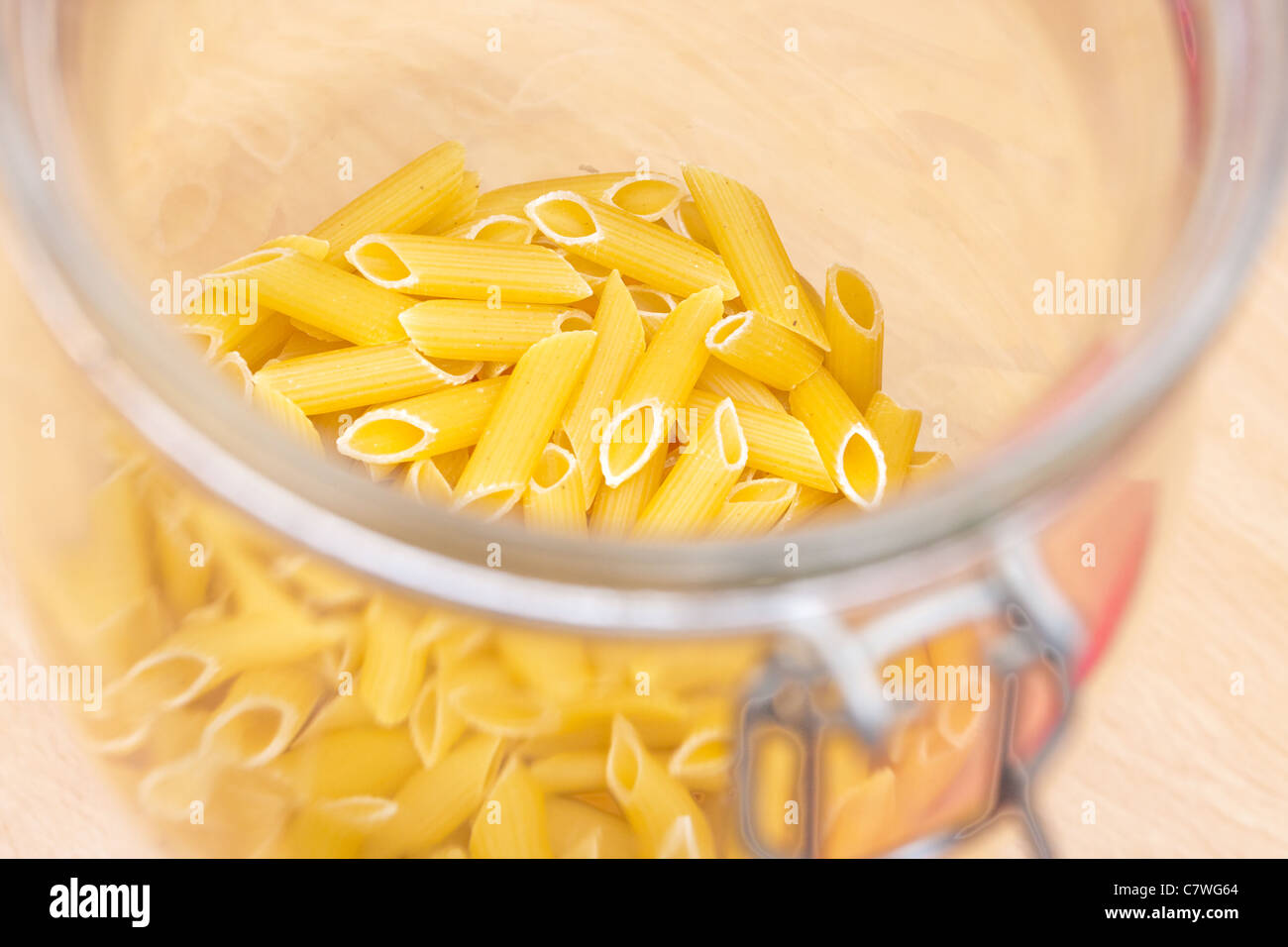Dry penne pasta in a glass jar Stock Photo - Alamy