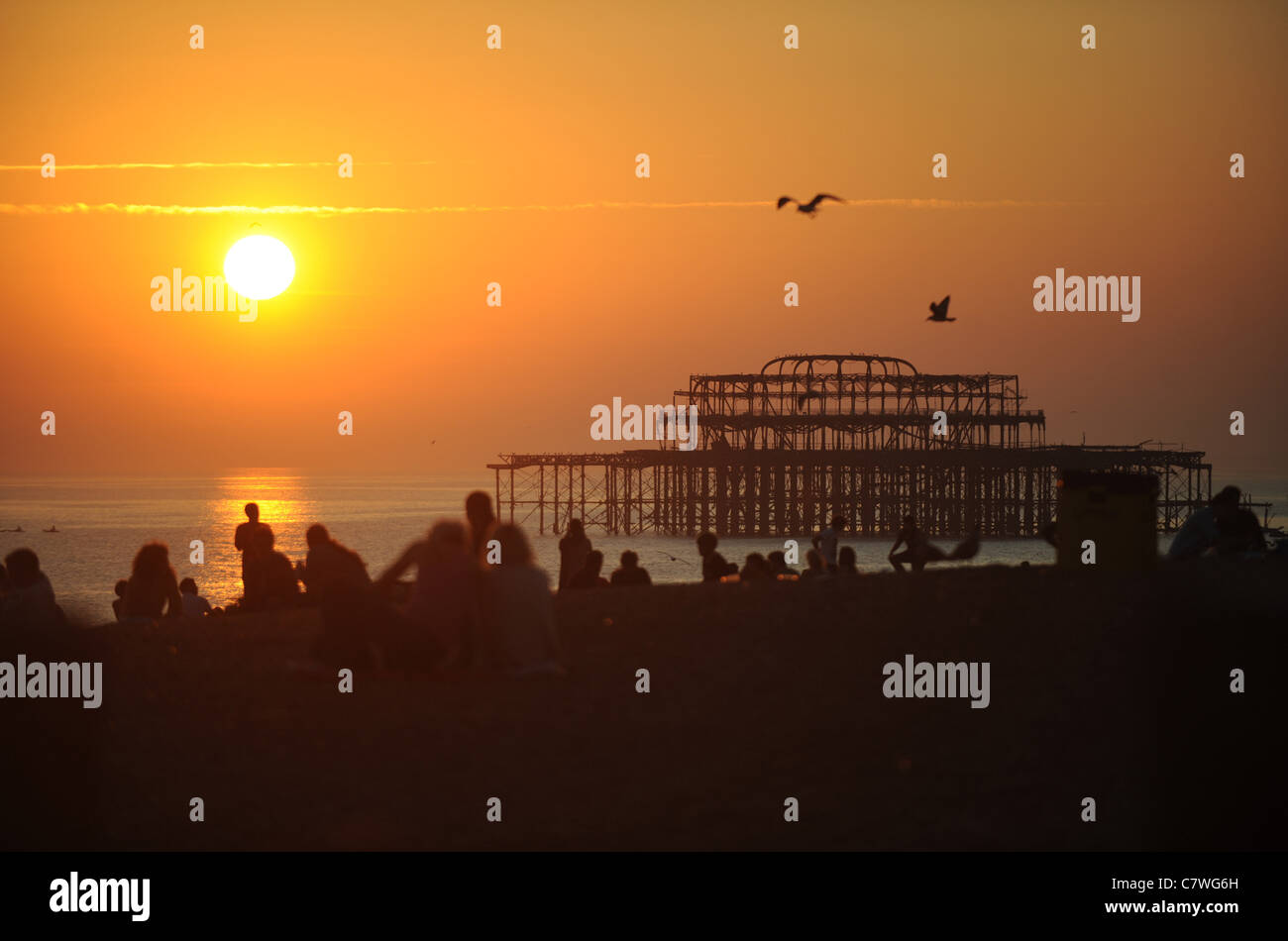 The sun sets over Brighton beach with the West Pier behind as the hot ...