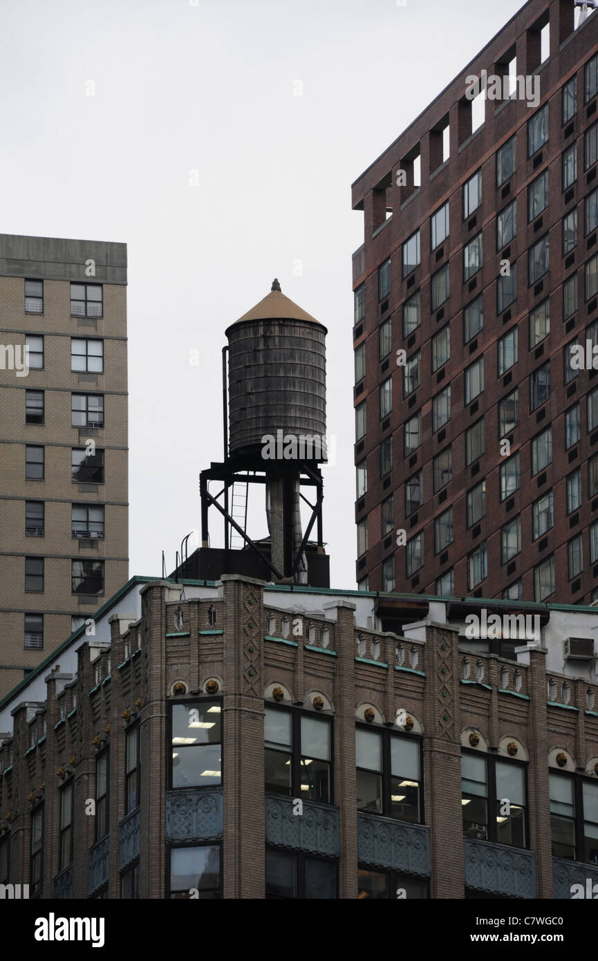 Tower block with strip light windows and wall corner rooftop water tank ...
