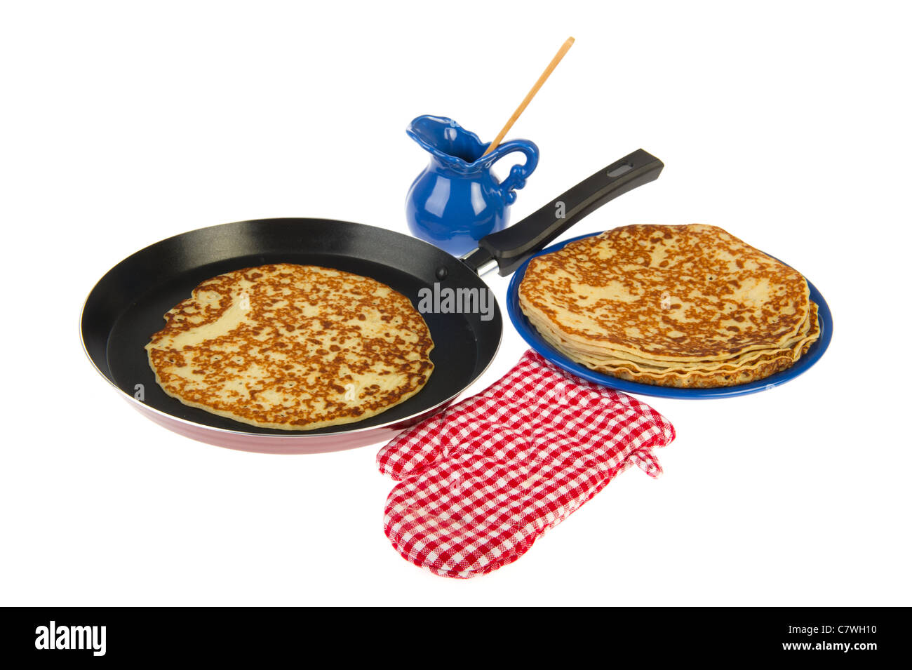 Frying pan with pancake isolated over white background Stock Photo - Alamy