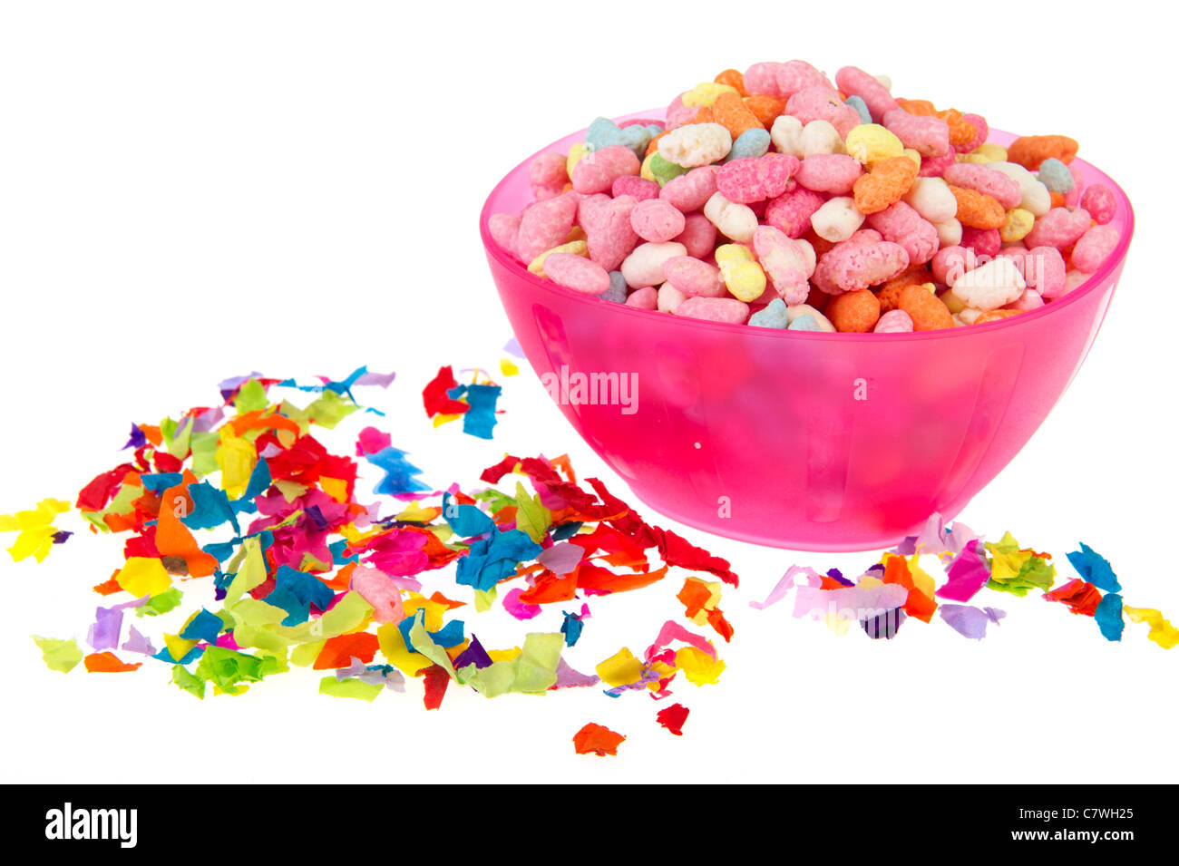 Pink bowl with colorful candy and confetti Stock Photo - Alamy