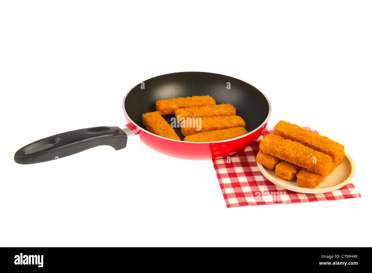 Red frying pan filled with fish sticks isolated over white background ...