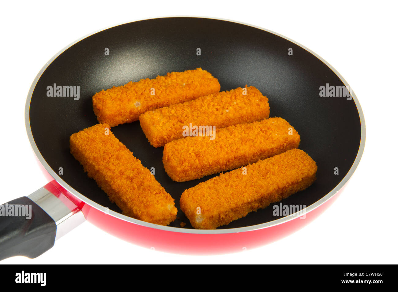Red frying pan filled with fish sticks isolated over white background ...