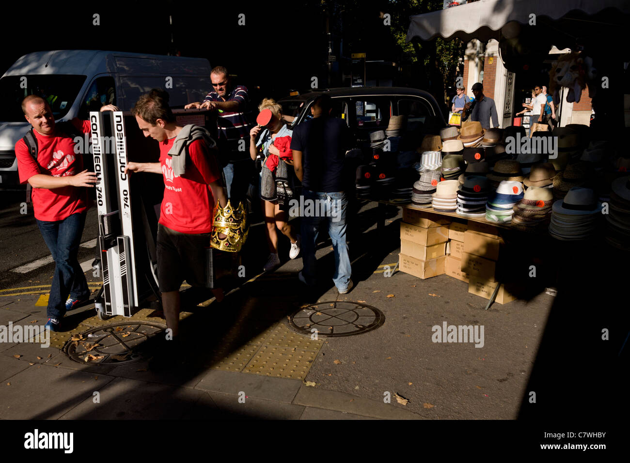 Group of friends or colleagues push a table tennis table along a west ...