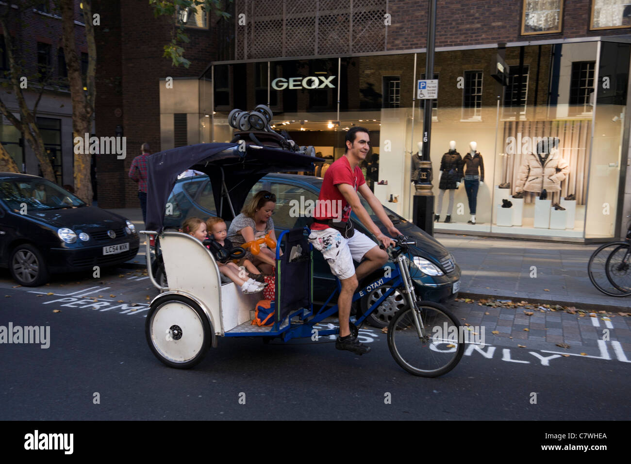 A mother sits alongside her young children whilst riding in a central ...