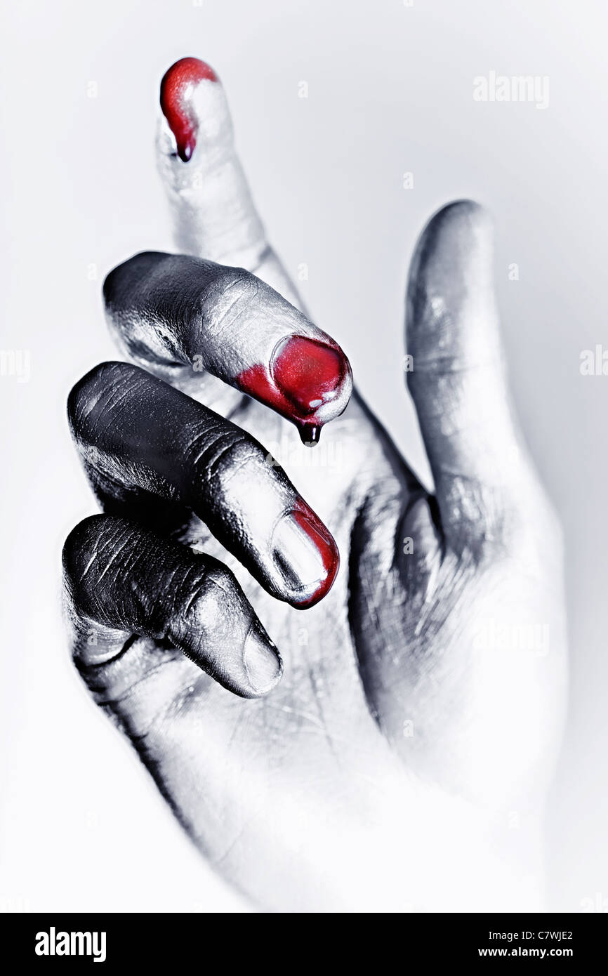 Beautiful male hand in silver paint with drops of blood Stock Photo - Alamy