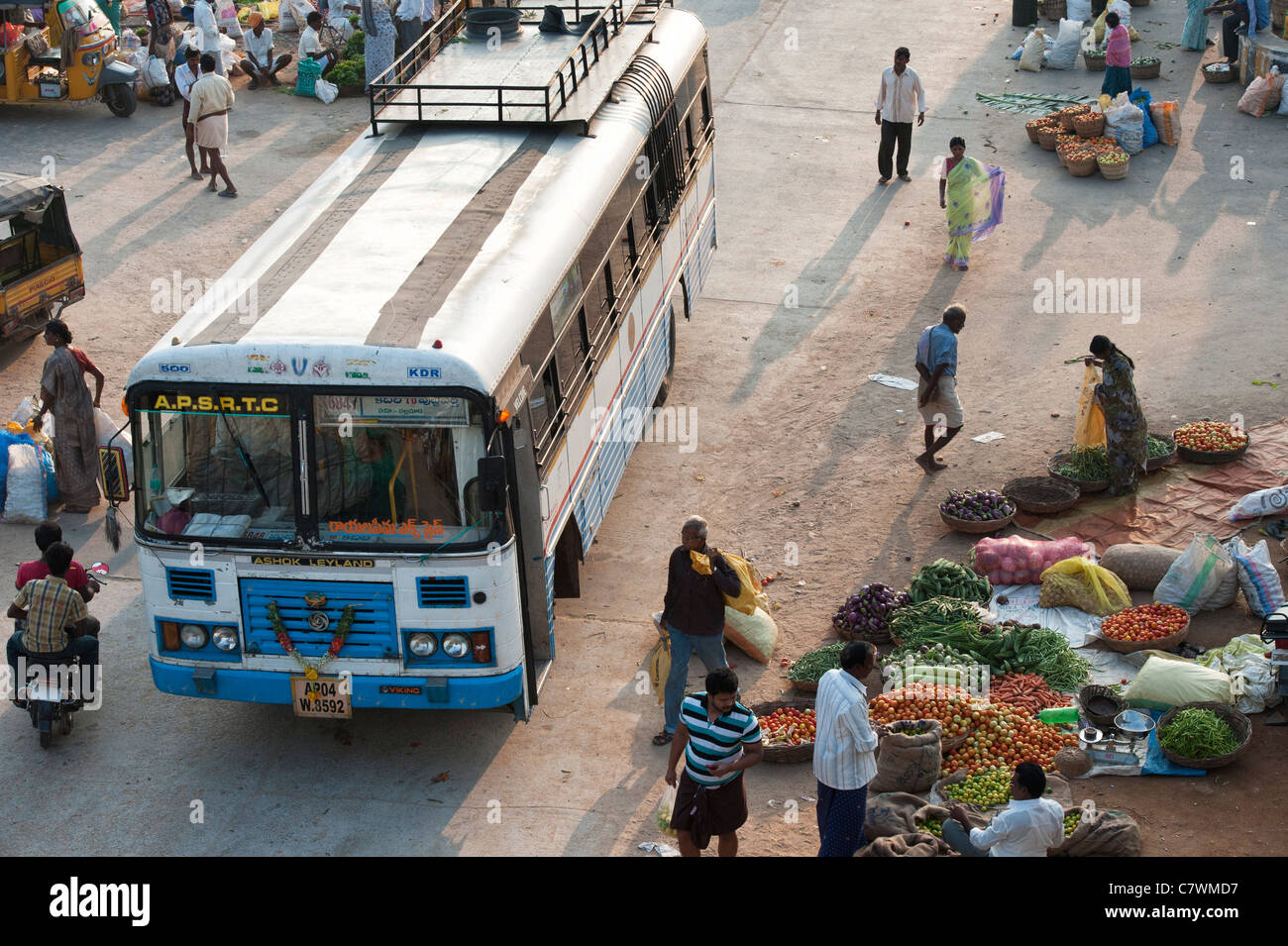 Looking down on an Indian bus driving through a street market in ...