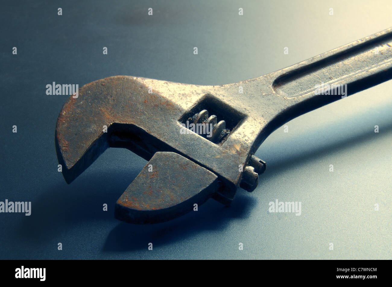 Old used adjustable spanner over metal background Stock Photo - Alamy