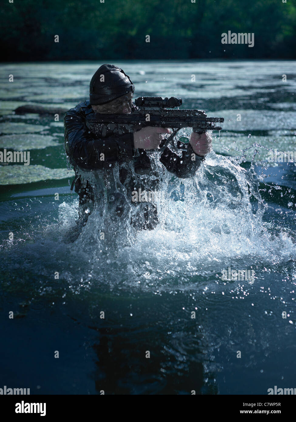 Special operations forces soldier emerges from water armed with a Steyr ...
