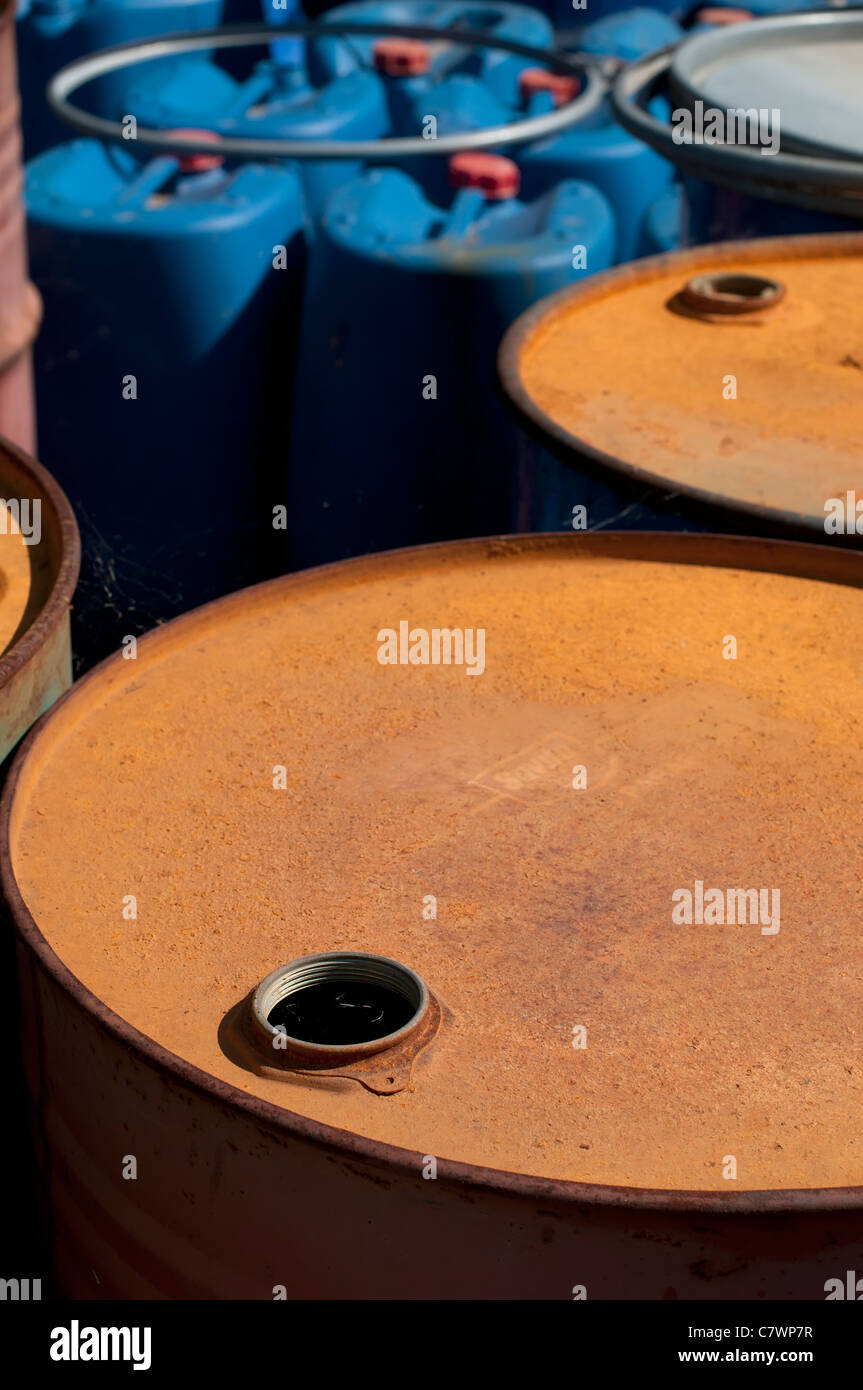 Old colored barrels for oil products. Empty rusted drums and blue ...
