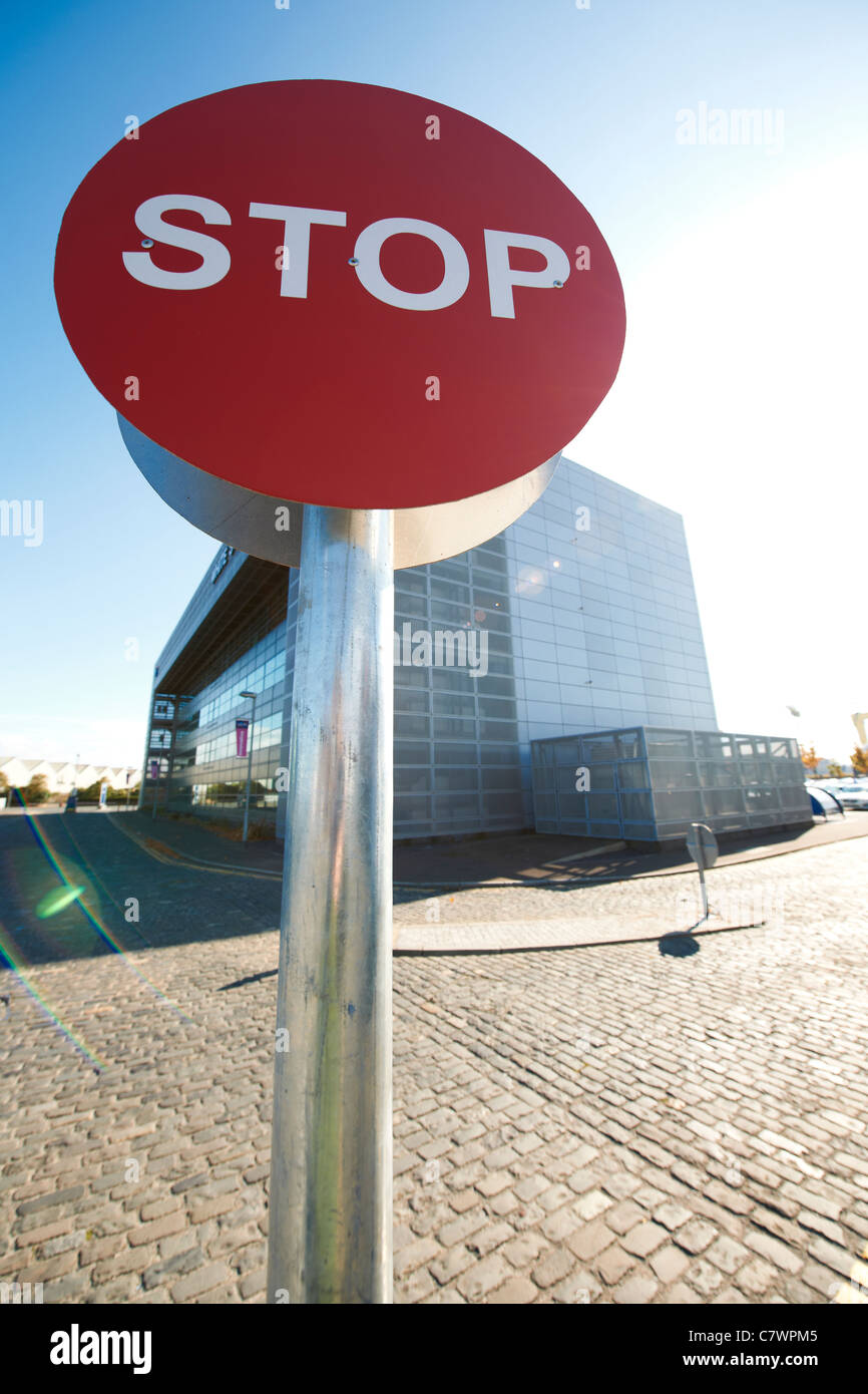 Red circular stop sign against urban scene Stock Photo - Alamy