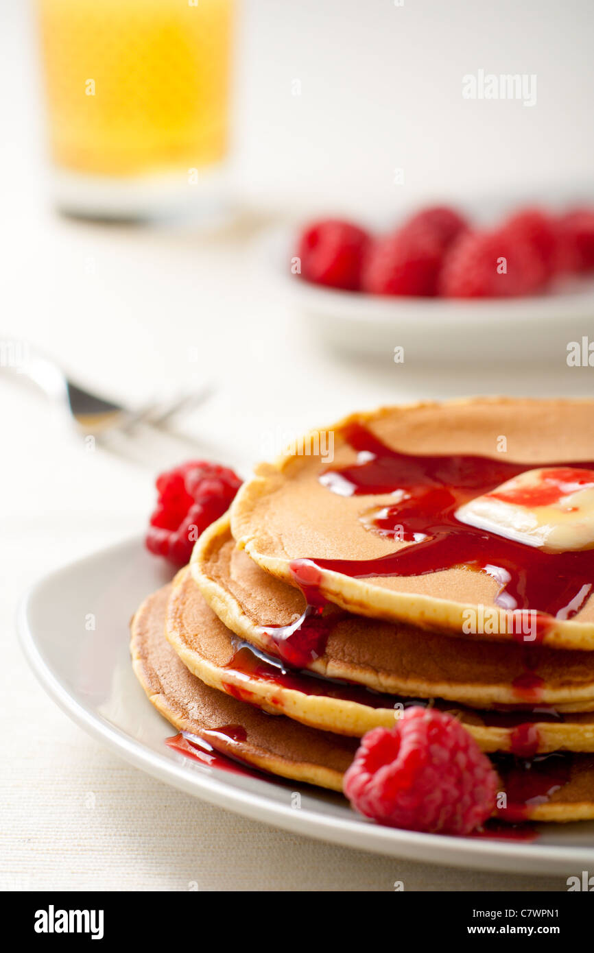 Pancakes with Raspberries, Syrup and Orange Juice Stock Photo - Alamy