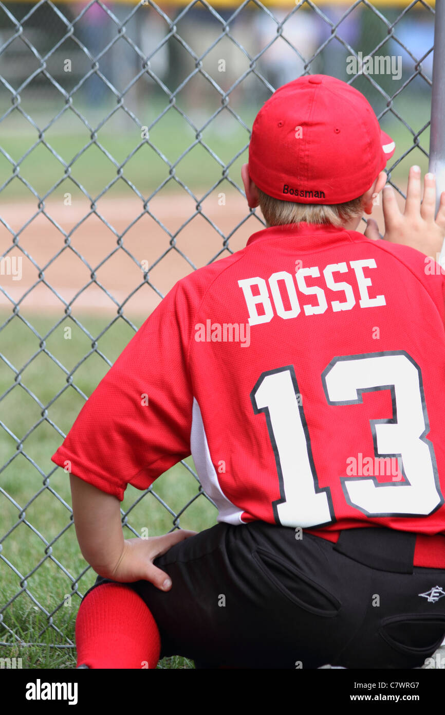 baseball player watching game from outside field farm league sitting ...