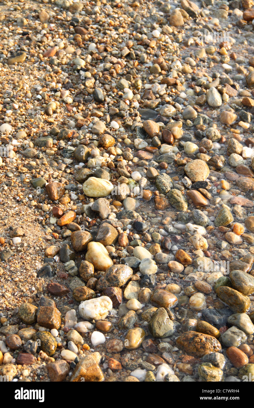 Beach with rocks at sunset different sizes of rocks sand water Stock ...