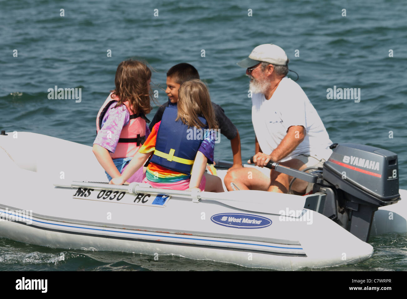 dinghy ride with the captain and kids fun fast action Stock Photo - Alamy