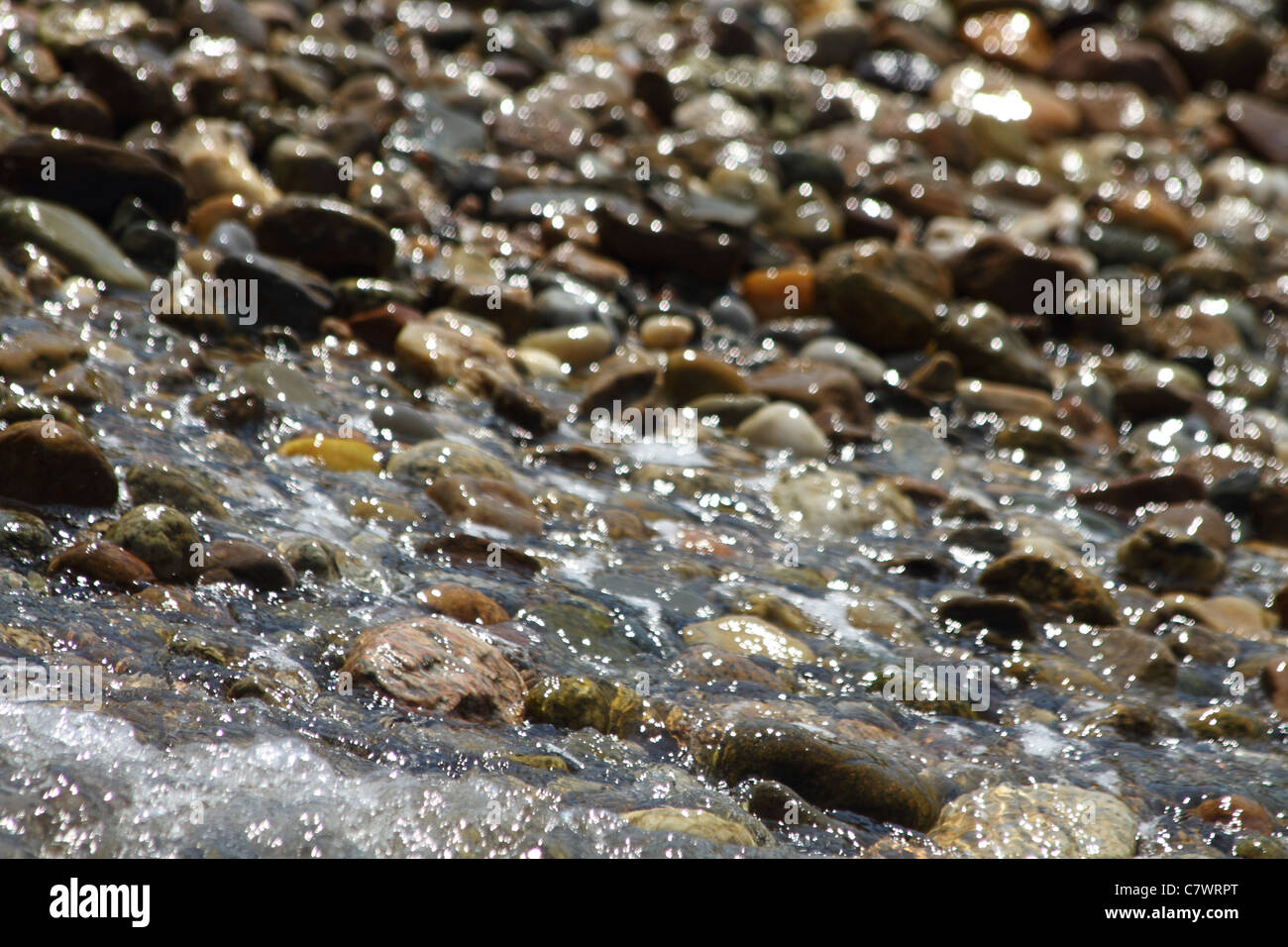 rocks in afternoon sun shining on rocks at the beach Stock Photo - Alamy
