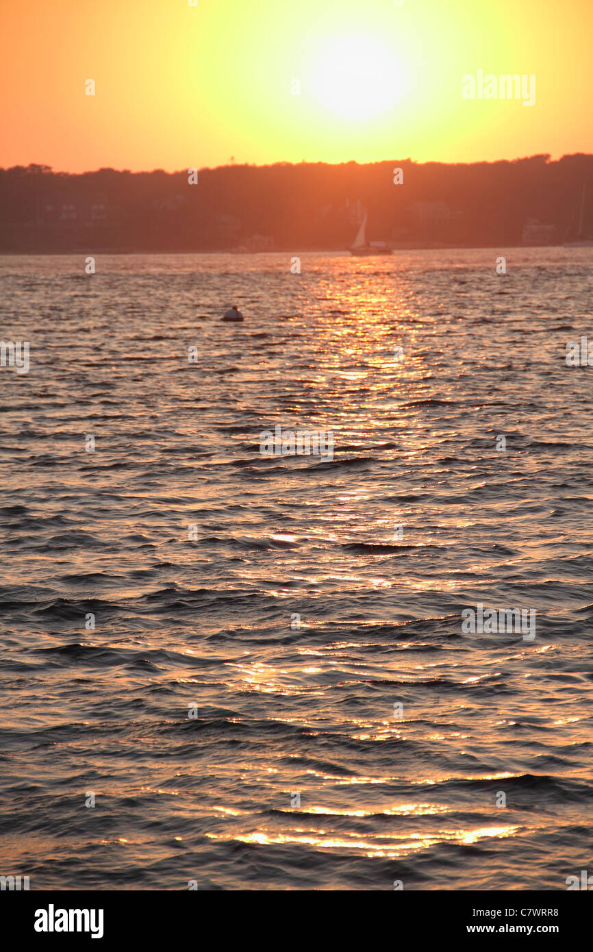sunset with black ocean ripples and bight orange sky Stock Photo - Alamy