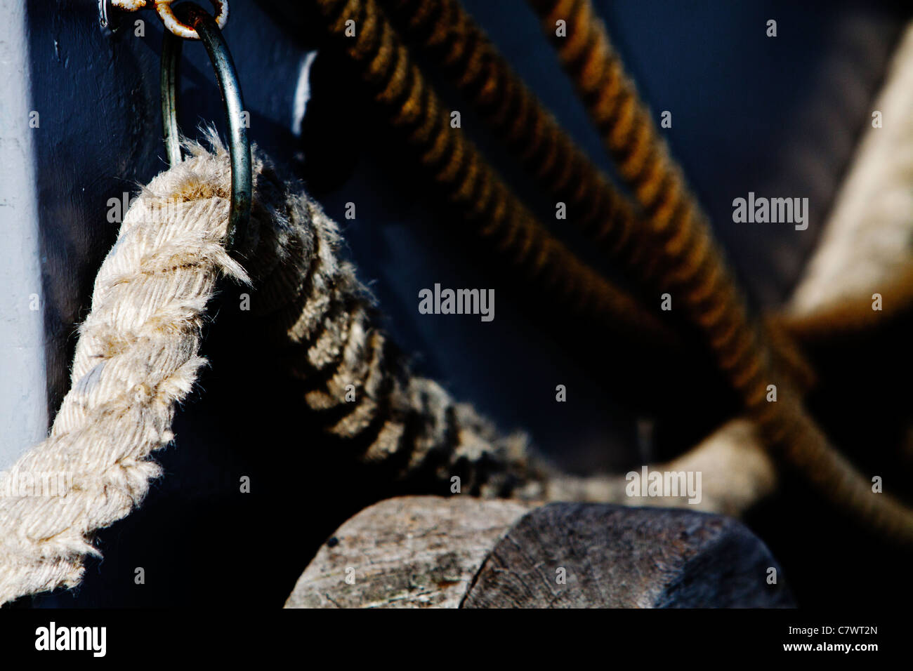 A old rope hanging off a hook Stock Photo - Alamy