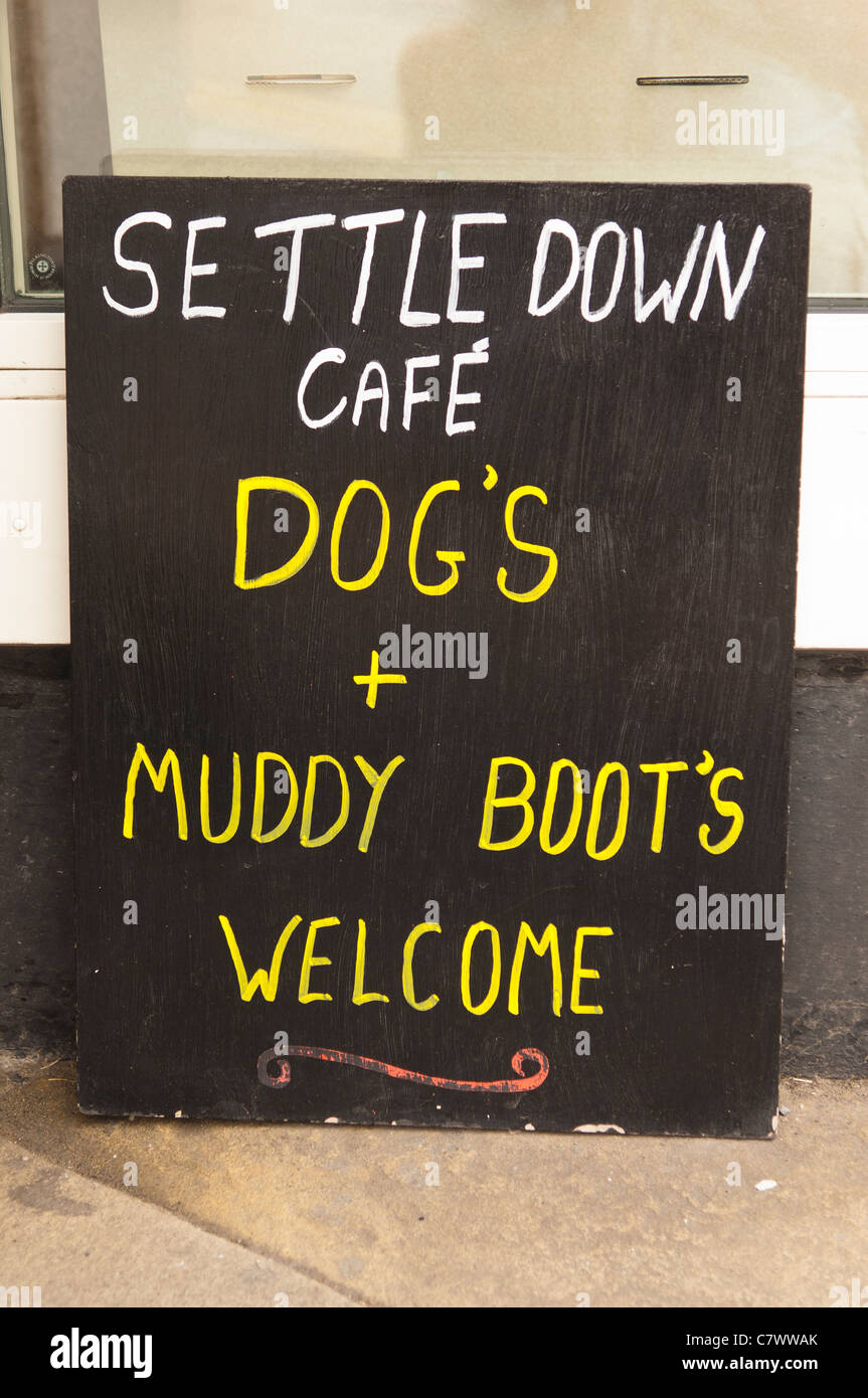 A sign welcoming dogs and muddy boots at a cafe in Settle in North ...