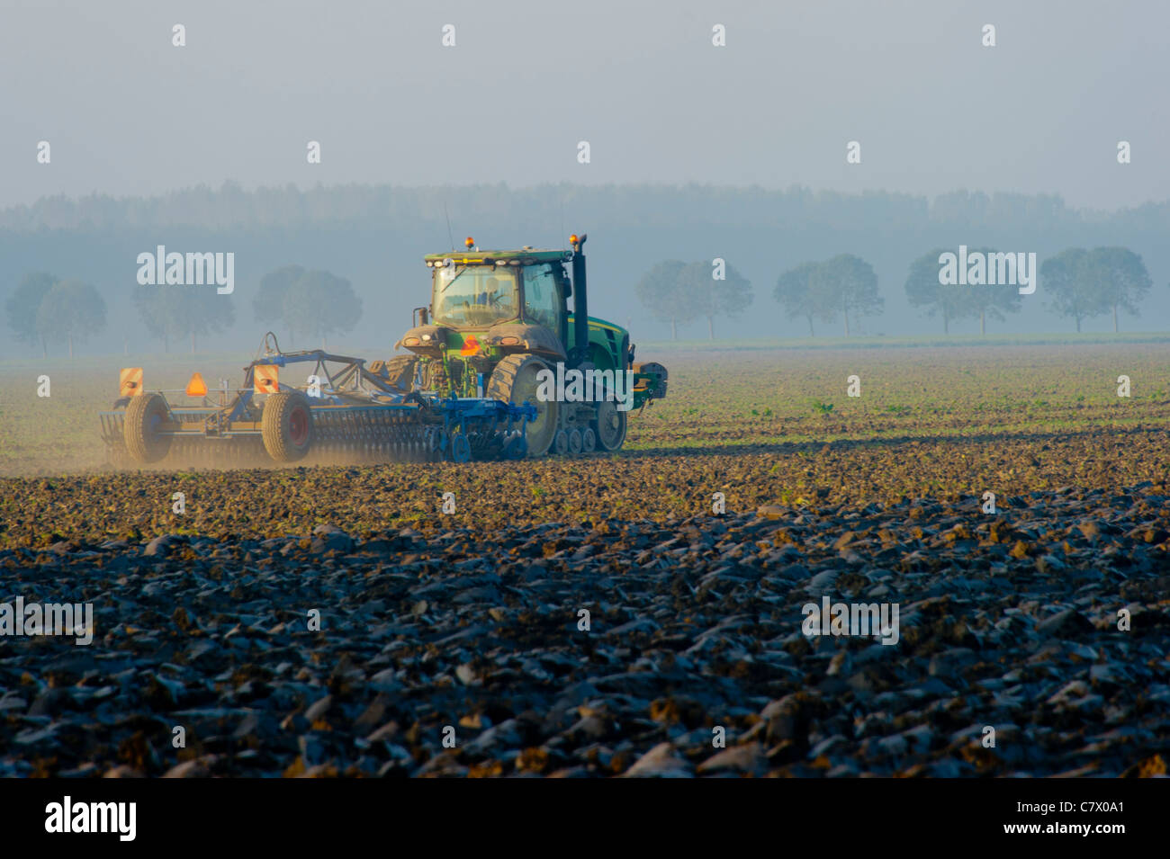 Machine on field plowing the land Stock Photo - Alamy