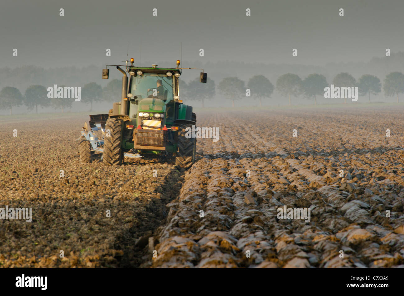Tractor in farm field Stock Photo - Alamy