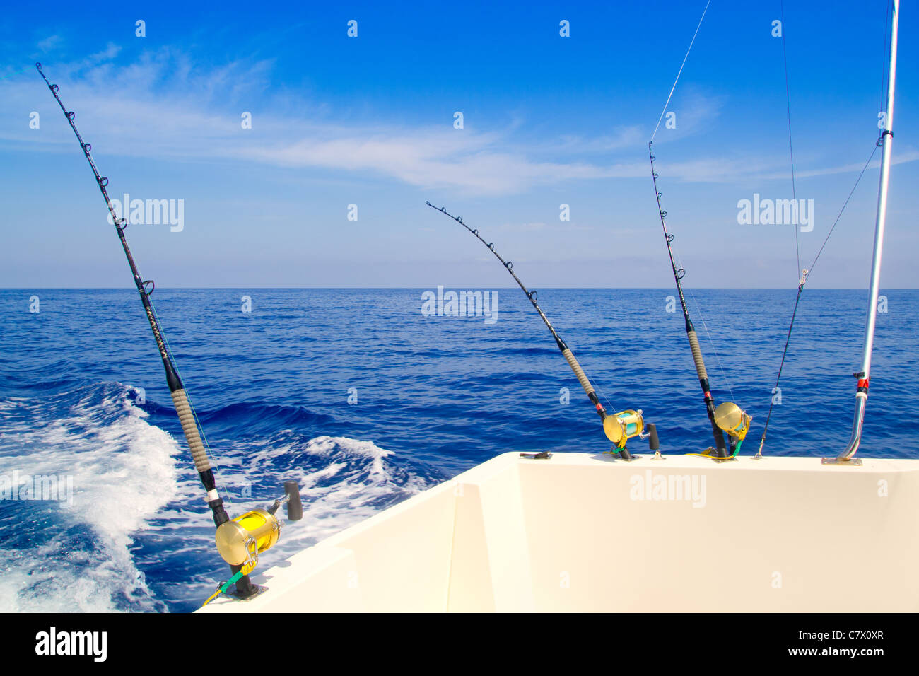 boat fishing trolling in deep blue sea with rods and reels Stock Photo ...