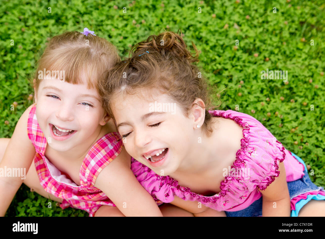 children girls laughing sitting on green grass park Stock Photo - Alamy