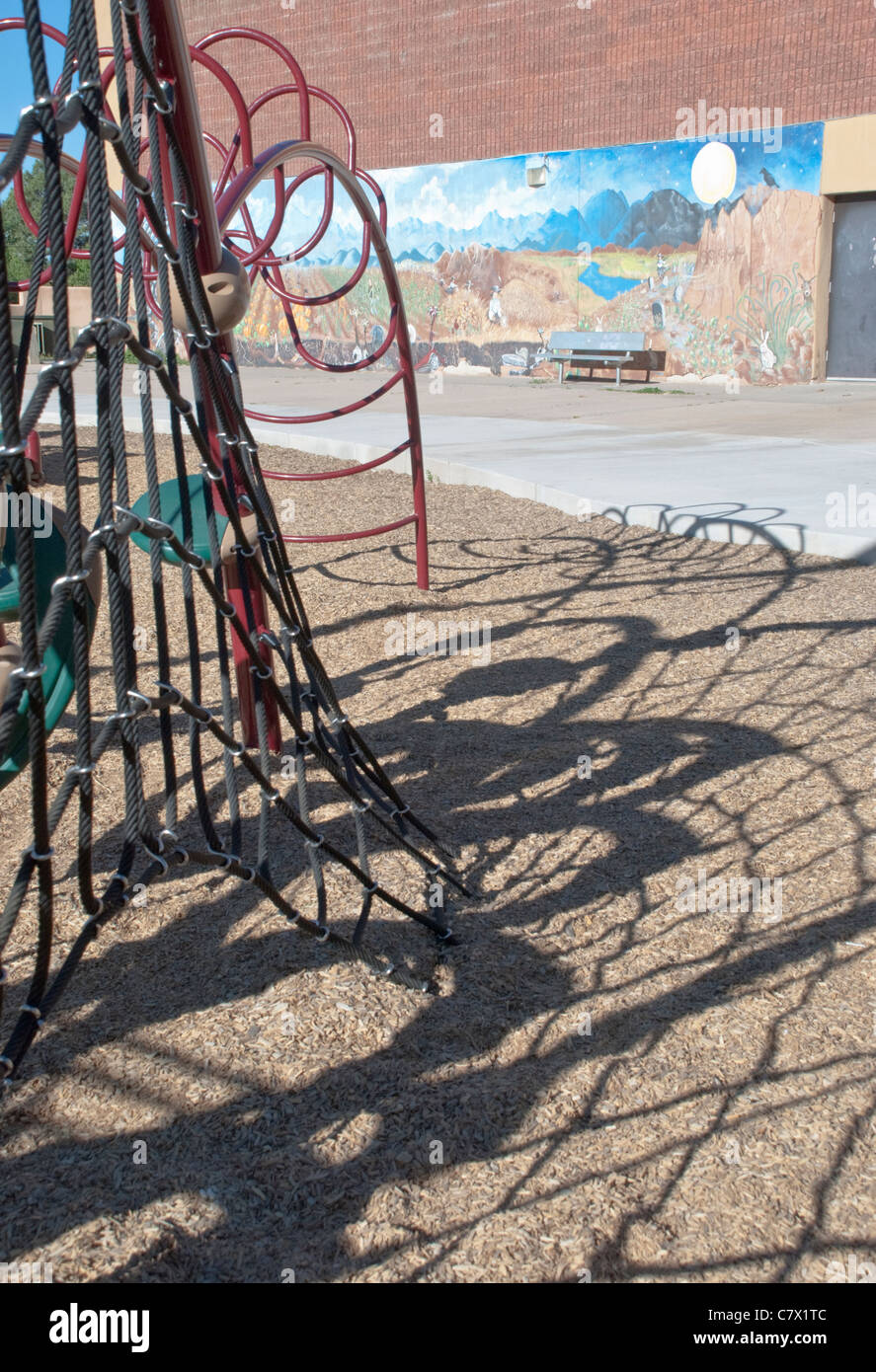 Shadows from playground equipment casts early morning shadows on an ...
