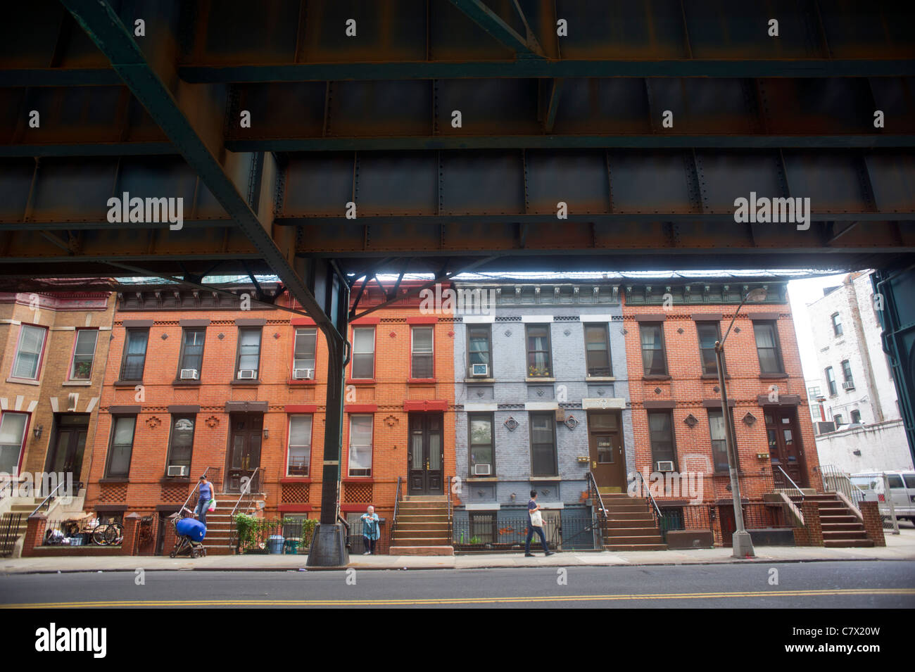 Attached houses under the elevated subway tracks in Long Island City ...