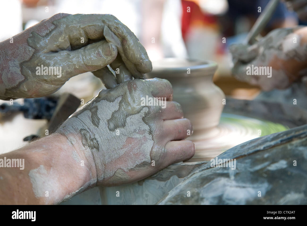 Potter shaping a ceramic pot on a pottery wheel Stock Photo - Alamy