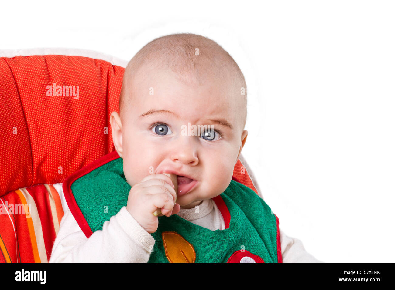 baby eating and looking to camera. isolated on white background Stock ...