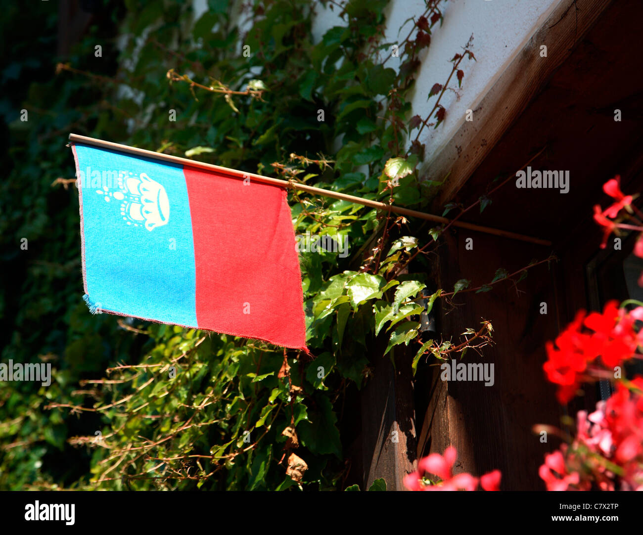 Liechtenstein Flag hanging from private house Stock Photo - Alamy
