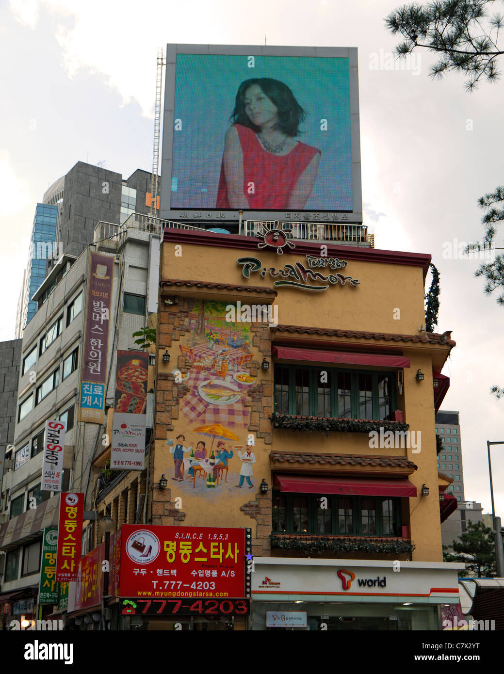 Small corner building in central Seoul with the outside wall painted to ...