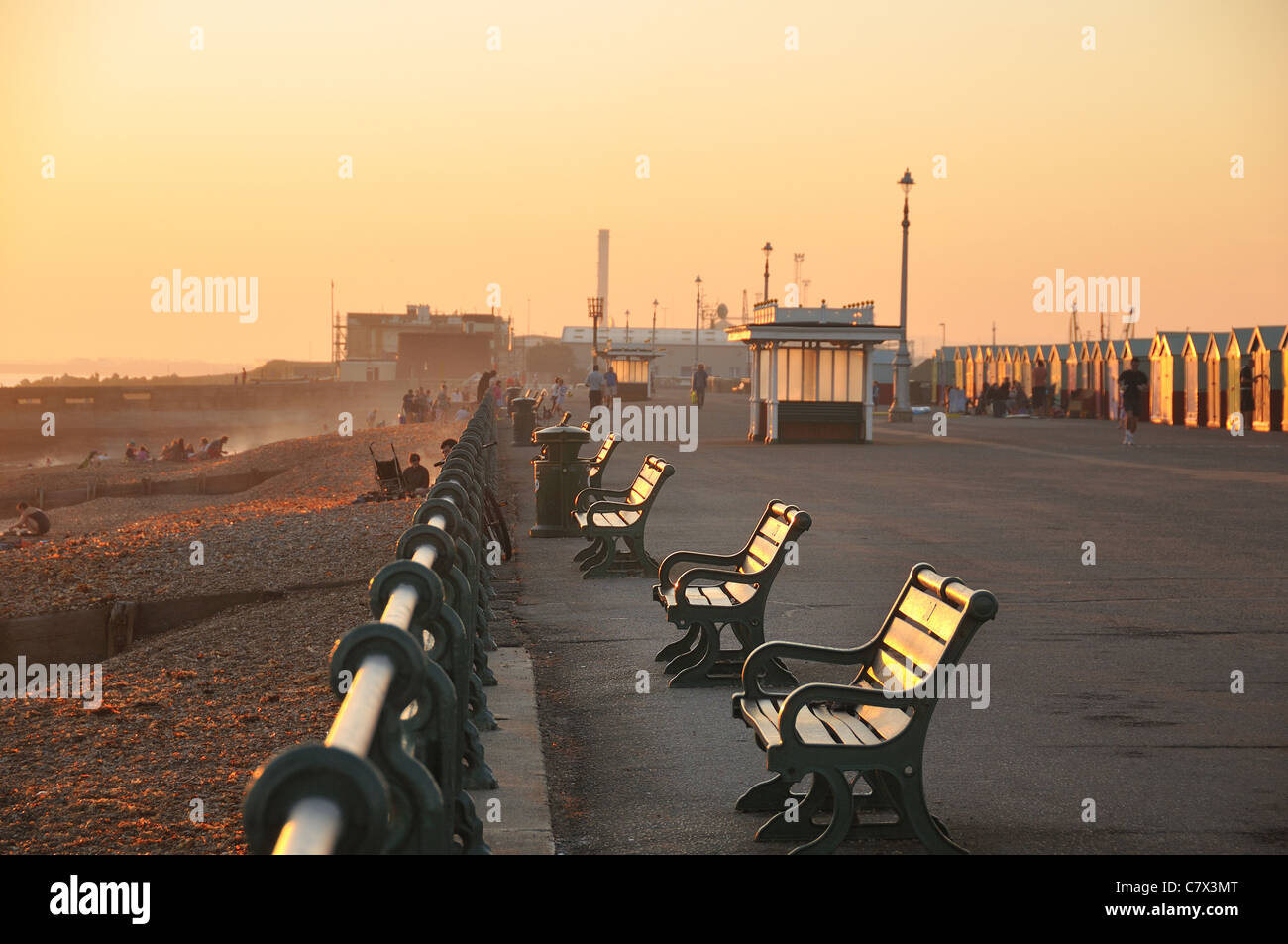 Back lit benches on the Brighton and Hove seafront during dusk, Hove ...