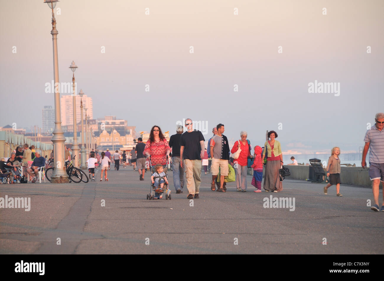 People walking on the Hove seafront at dusk, Hove, UK Stock Photo - Alamy
