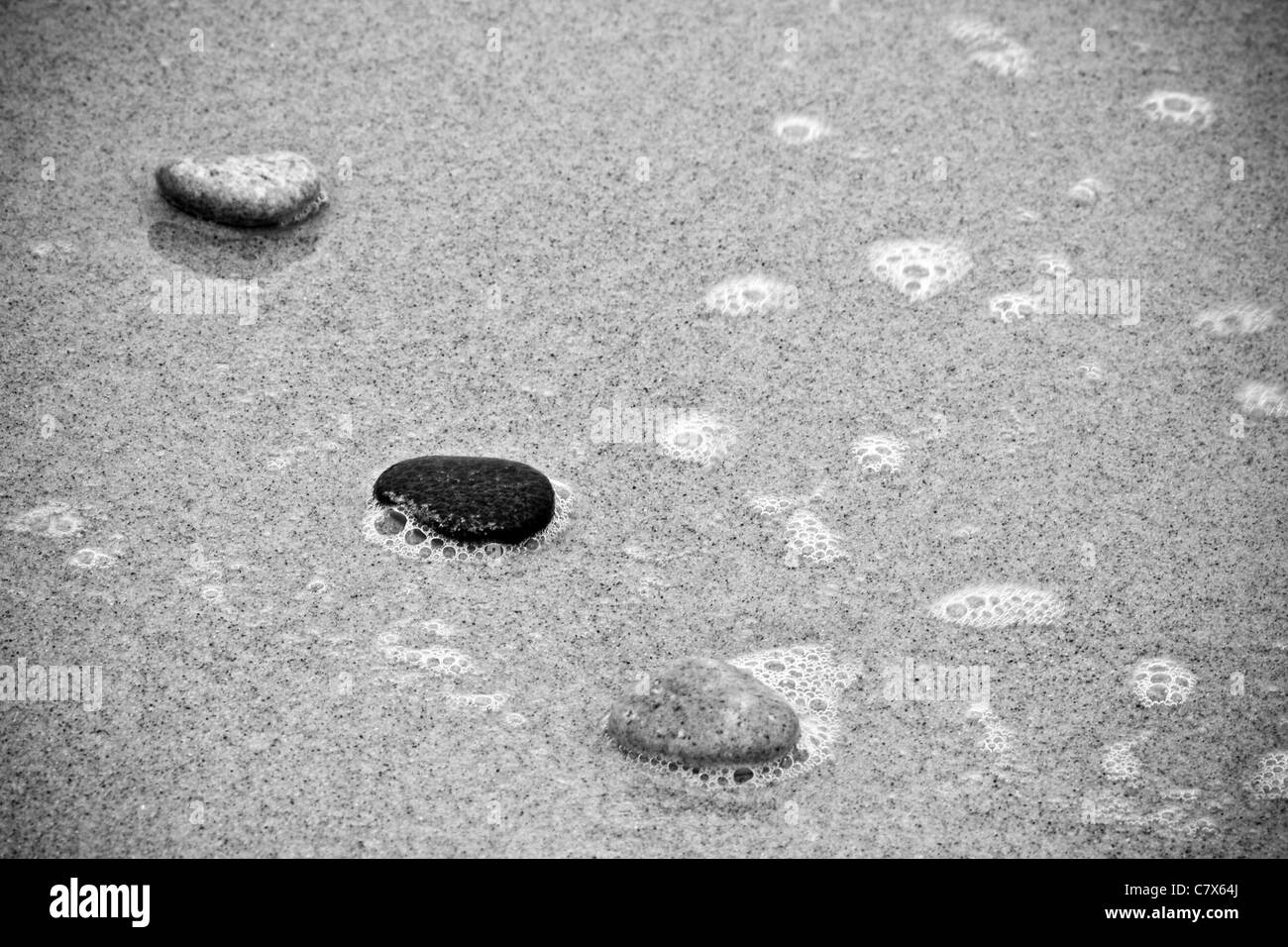 Three stones in the sand and surf on Carmel Beach, California Stock ...