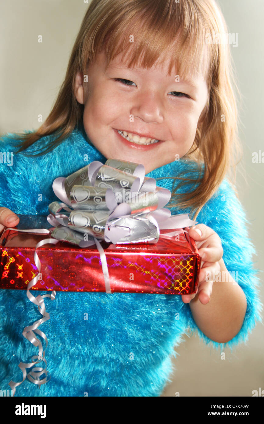 Very happy girl holding a gift box Stock Photo - Alamy