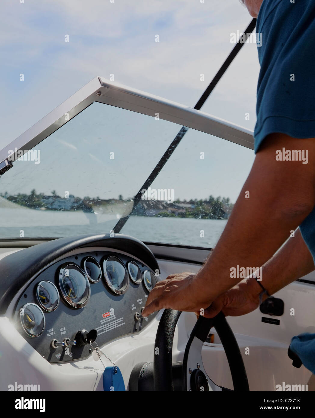 abstract concept portrait of man steering a speed boat in open waters ...