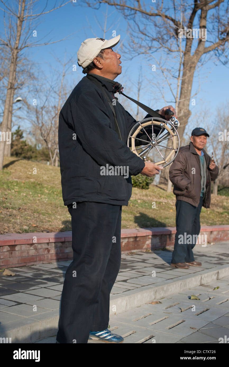 Two old men fly a kite in the park in Beijing Stock Photo - Alamy