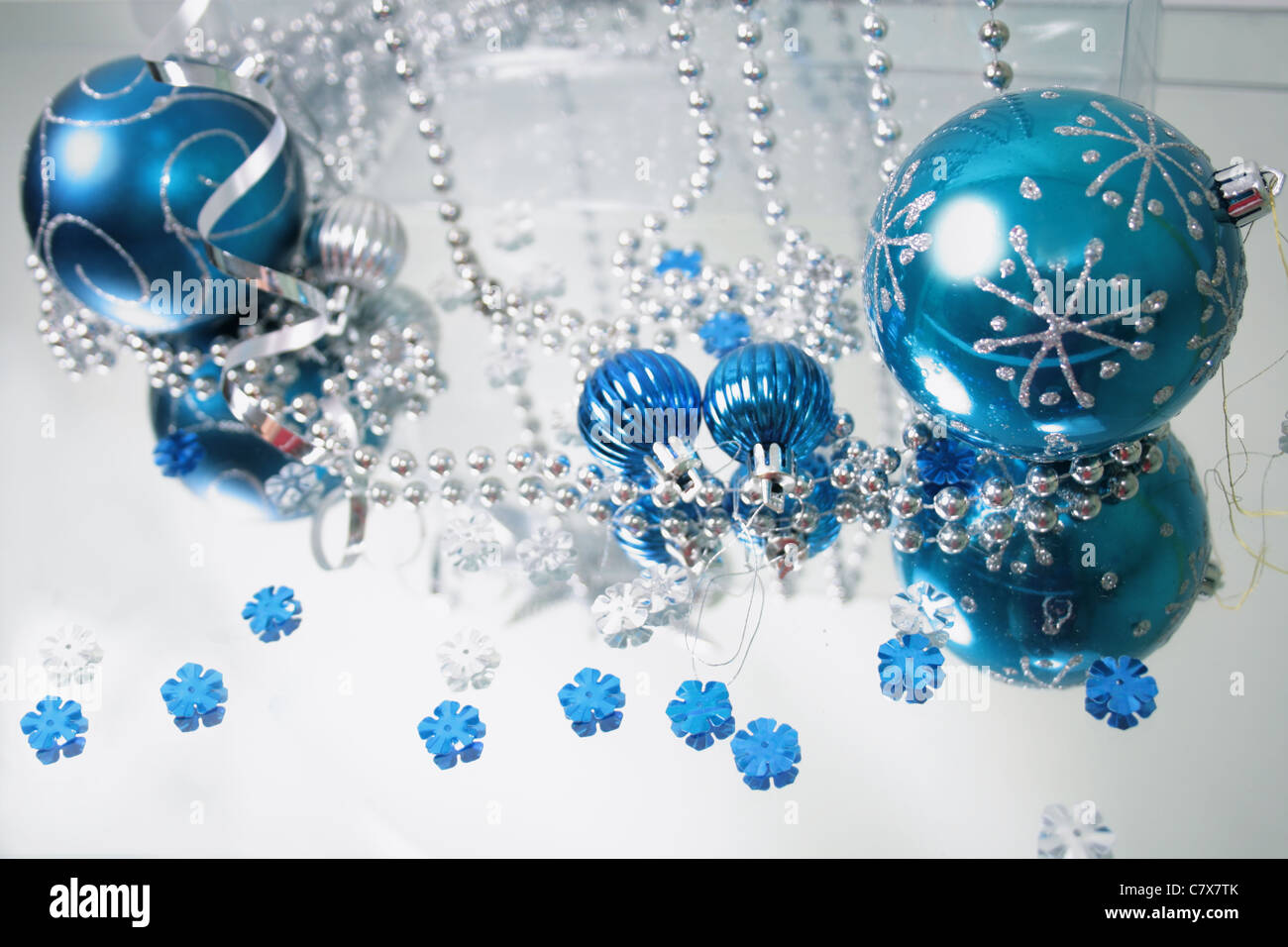A lovely blue baubles on a mirror surface with ribbons and beads Stock ...