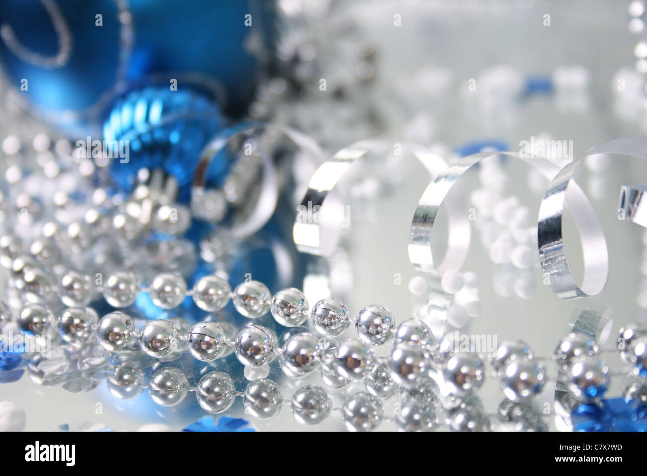 A lovely blue baubles on a mirror surface with ribbons and beads Stock ...