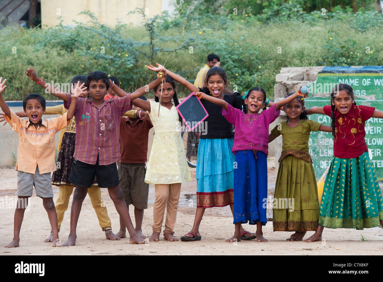 Happy young rural Indian village children laughing waving and smiling ...