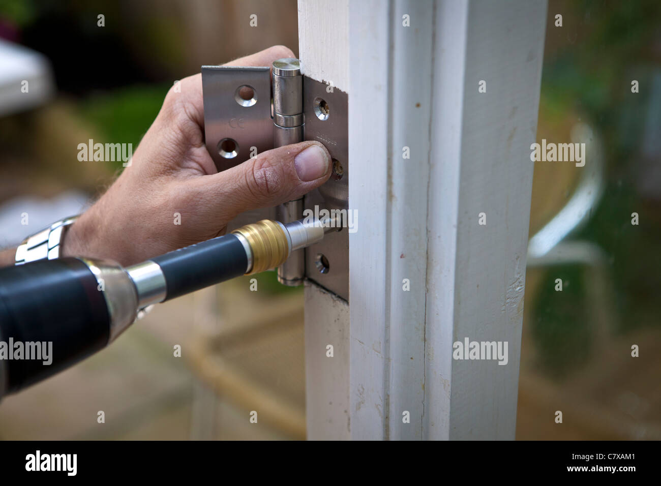 Carpenter hanging conservatory door Stock Photo - Alamy