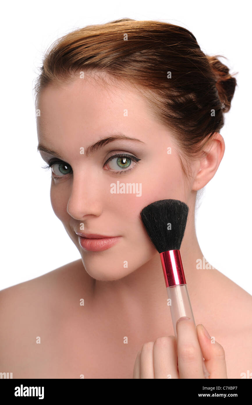 Young woman portrait applying makeup isolated on a white background ...