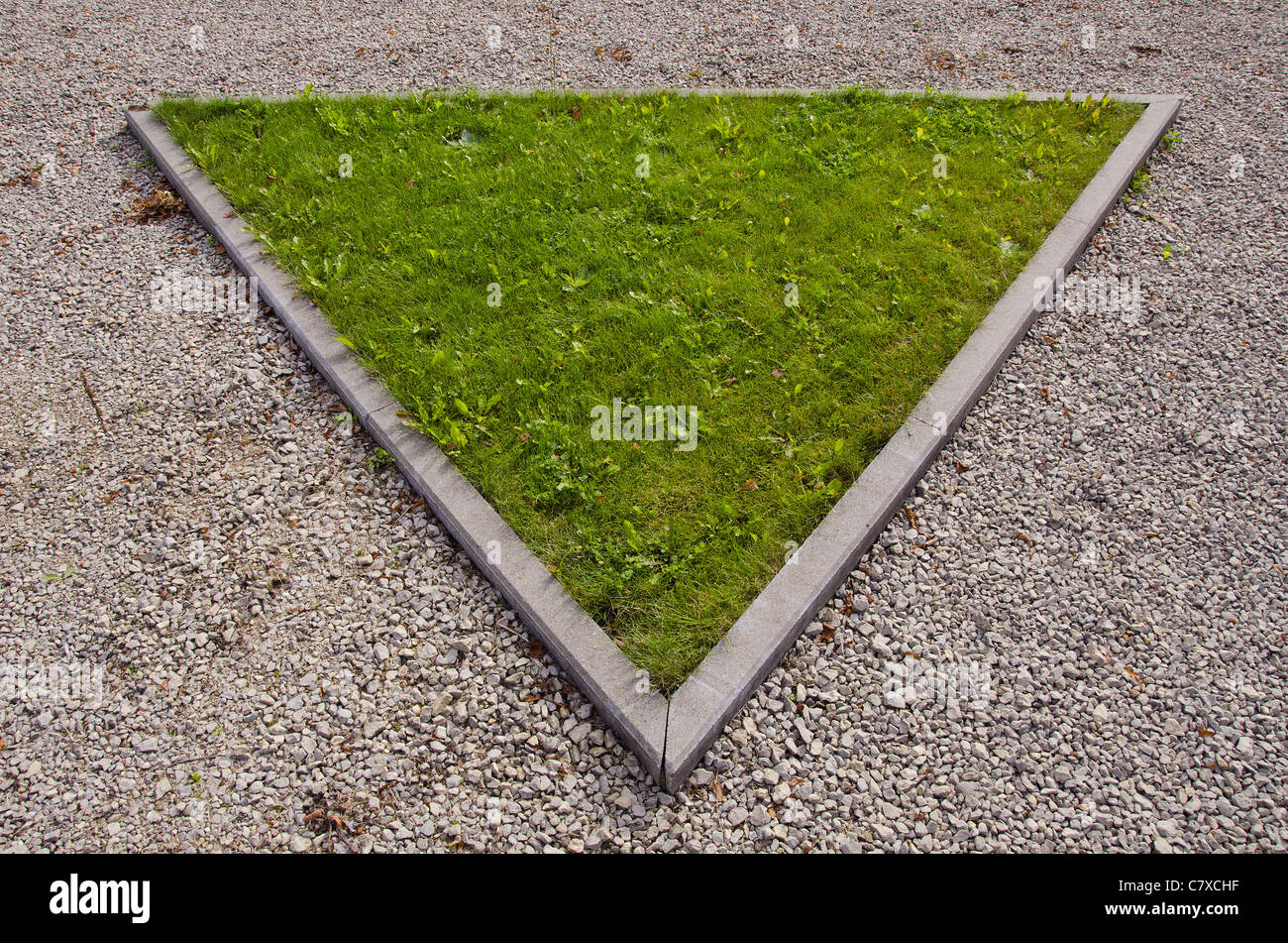 Green triangular island of grass surrounded by path in park Stock Photo ...